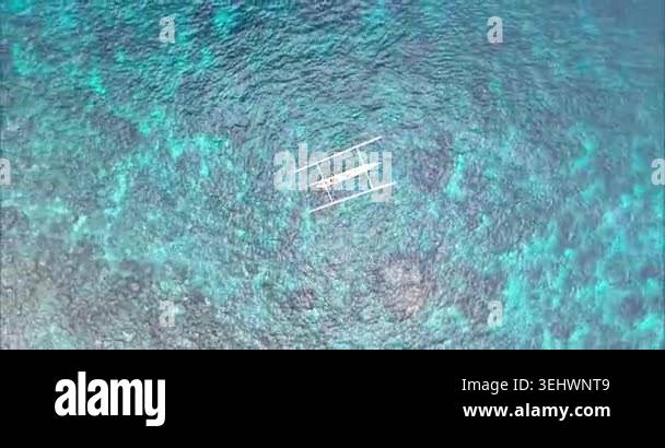 Overhead aerial drone shot of a traditional Balinese jukung boat ...