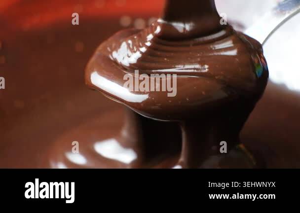 Melted dark chocolate flowing into a spoon slow motion Stock Video ...