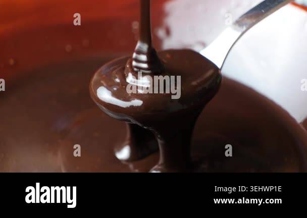 Melted dark chocolate flowing into a spoon close-up Stock Video Footage ...