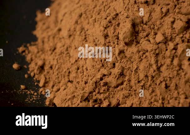 Rotating pile of organic cocoa powder on dark background Stock Video ...
