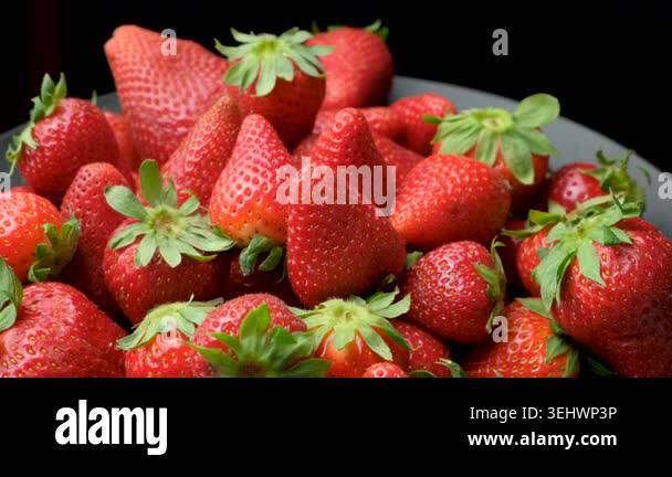 Ripe strawberries on dark background rotating Stock Video Footage - Alamy