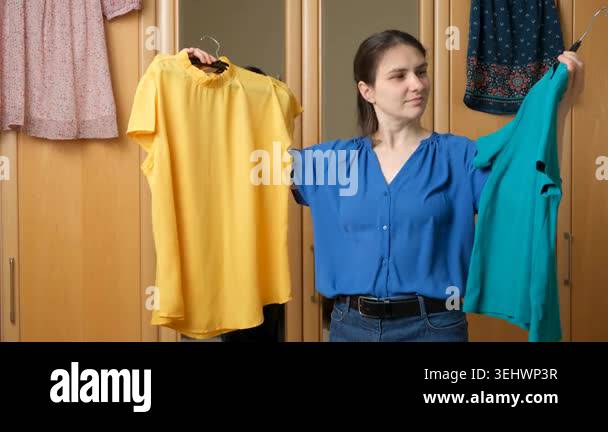 Woman selecting wardrobe garments that match her deep winter personal ...