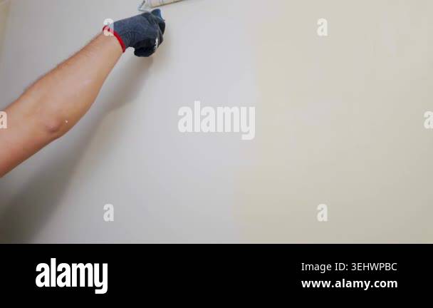 Person painting interior wall with roller in home renovation Stock ...