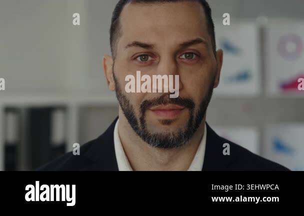Portrait of bearded Arab businessman in formal suit stands in corporate ...