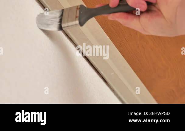 Textured Paintable Wallpaper. man paints textured wallpaper white using ...