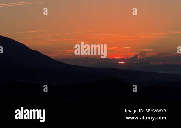 Panoramic mountain landscape at dawn with mist, low clouds, golden ...