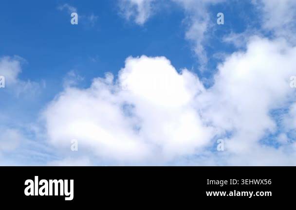 White clouds float slowly across the blue sky in the wind Stock Video ...