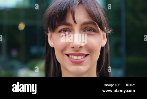 Close up portrait of a beautiful young Caucasian woman smiling and ...
