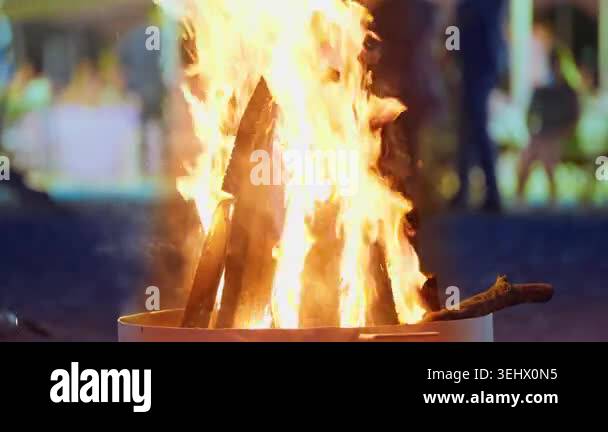 A beautiful bonfire on the ocean beach at a hotel on a tropical island ...