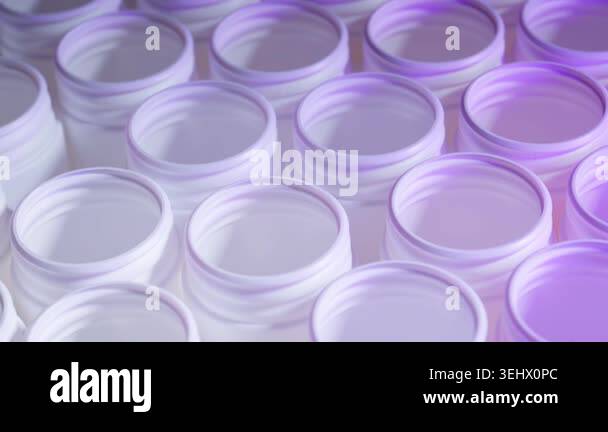 Close-up of a large group of white plastic bottles lined up in a ...