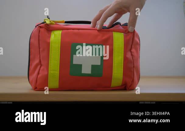 Hand is grabbing first aid kit Stock Video Footage - Alamy
