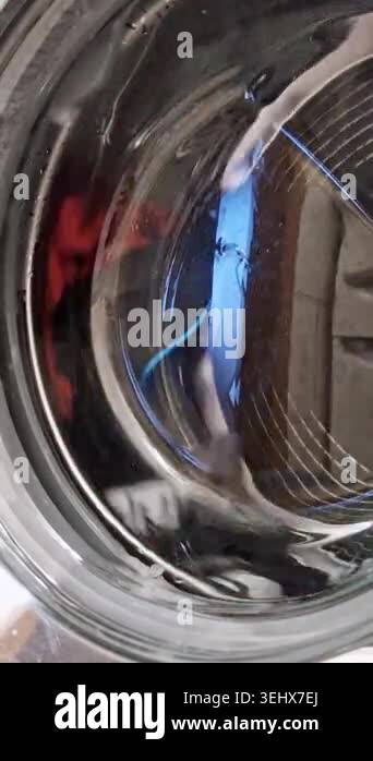 Vertical, close up view from inside a front-load washing machine drum ...