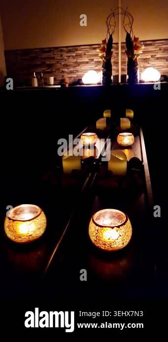 Interior view of a spa and wellness area. Lit candles in mosaic glass ...