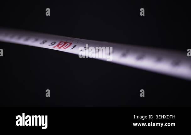 A macro view of a white measuring tape extending diagonally over a ...