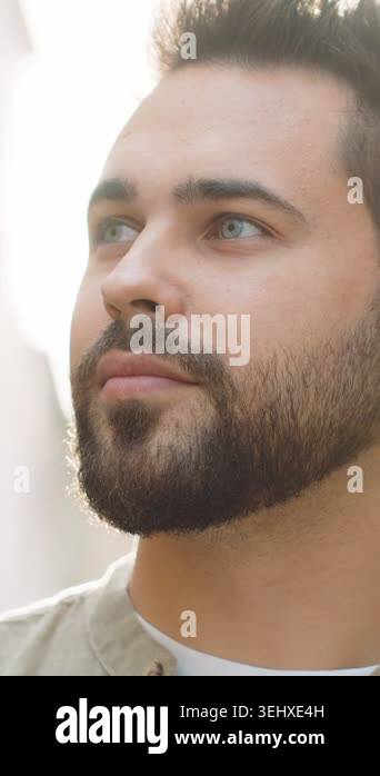 Close-up portrait of happy young man face smiling friendly open eyes ...