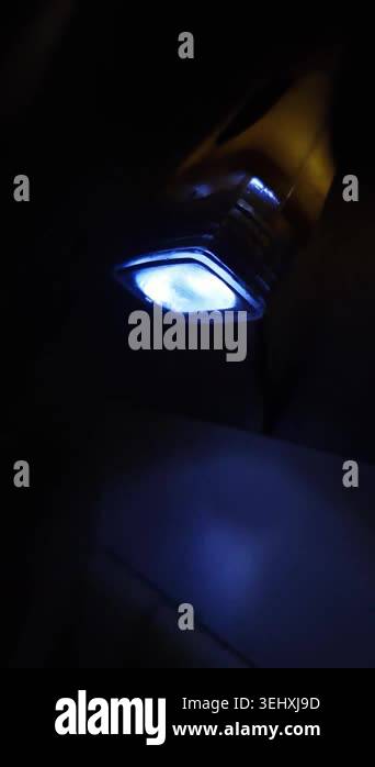 A single futuristic light with a blue hue flickers erratically in a ...