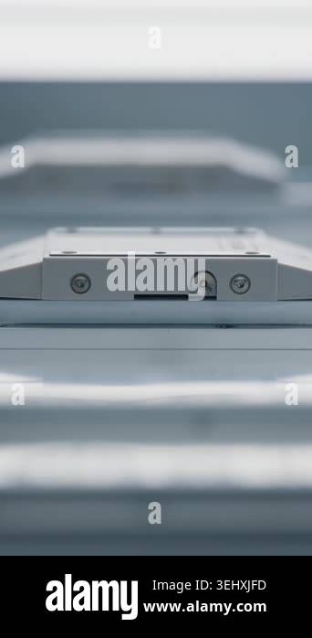 Macro close up of metal mechanical component with screws and clean ...