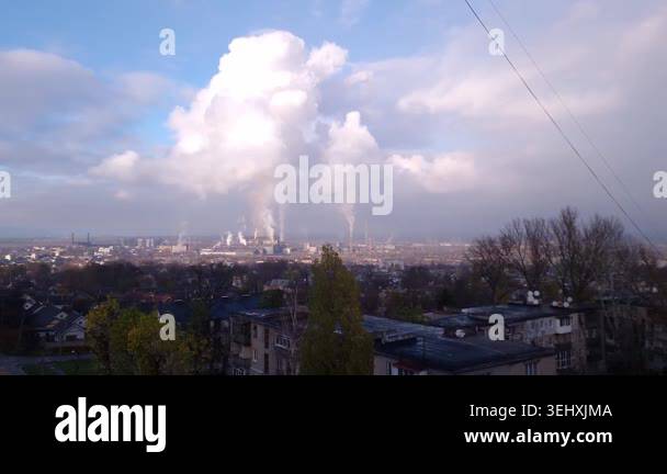 Industrial complex releases large plumes of smoke from its smokestacks ...