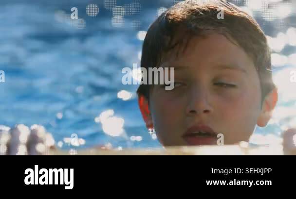 Side profile of boy resting quietly at pool edge, gazing across ...