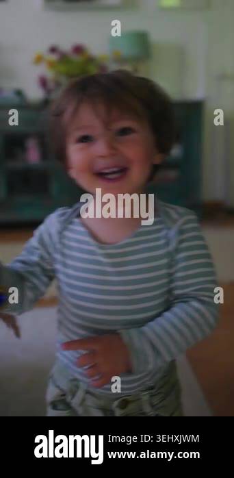 Young child grips toy sword with excited expression, capturing pretend ...