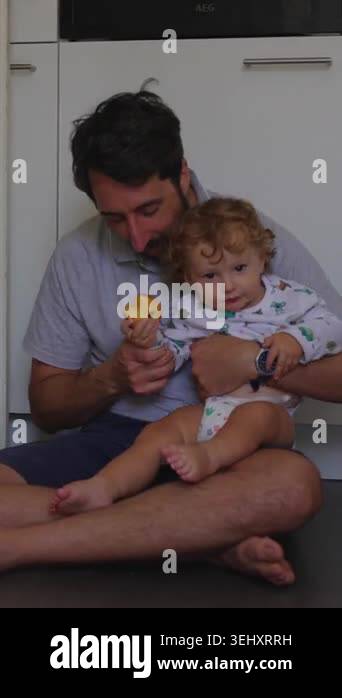 Dad and young child enjoying carefree activity inside cozy apartment ...