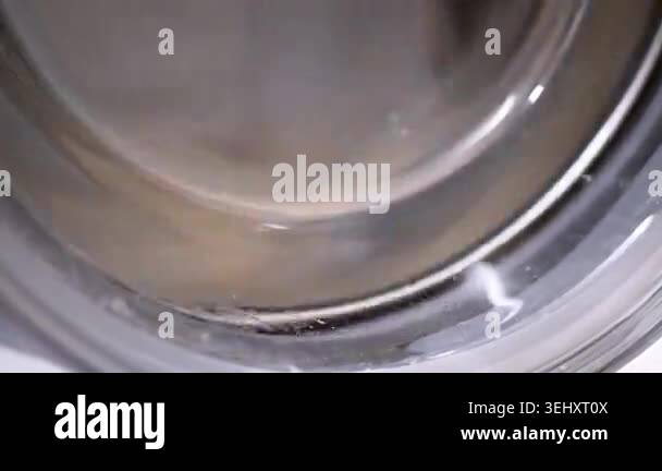 Close-up of a washing machine drum spinning at high speed with wet ...