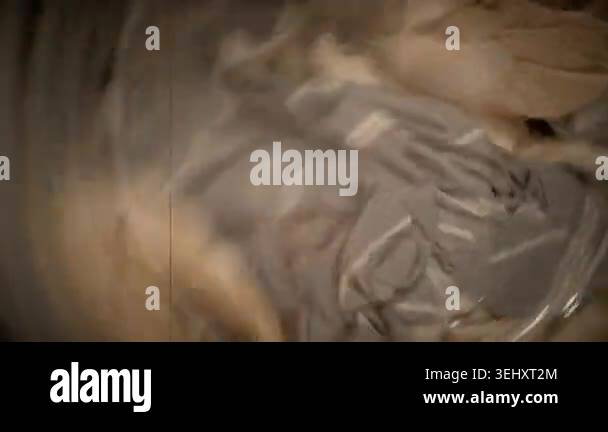 Mixed clothes tumble rapidly inside the rotating drum of a front ...
