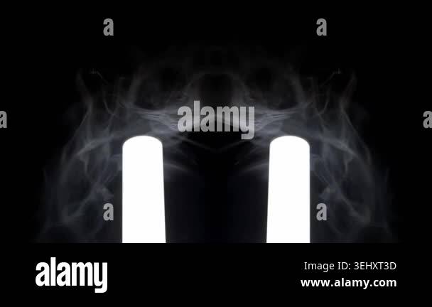 Two glowing white vertical lights stand in the dark as mirrored smoke ...