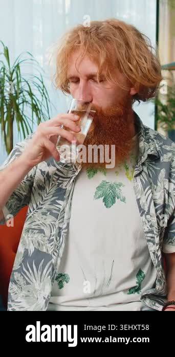 Thirsty man hold glass of natural filtered aqua make sips drinking ...
