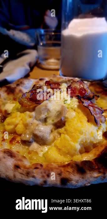Freshly baked breakfast pizza has fluffy scrambled eggs, crispy bacon ...