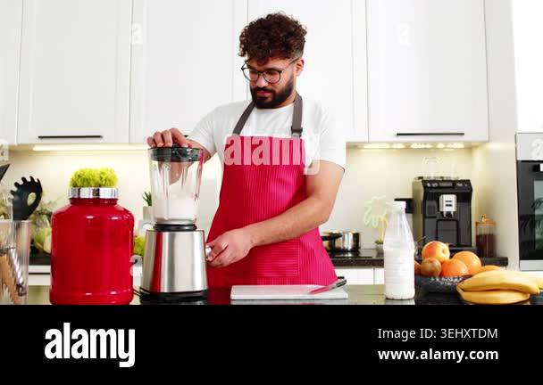 Arabian man blends milk whey protein banana apple smoothie for post ...
