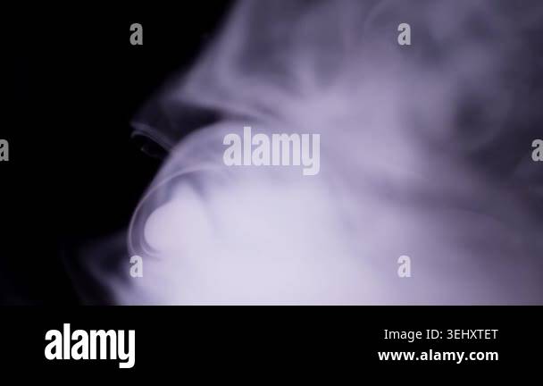 A thick cloud of white smoke billows and swirls in slow motion ...