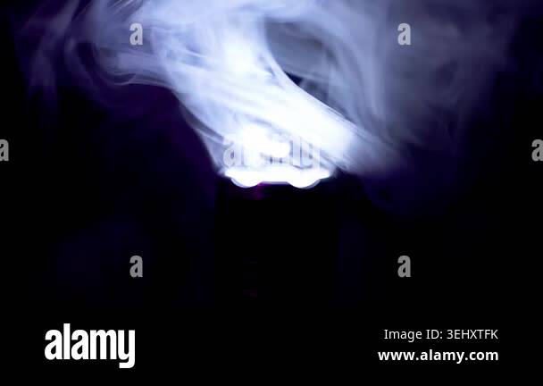 A vertical flashlight beam cuts through darkness, illuminating swirling ...