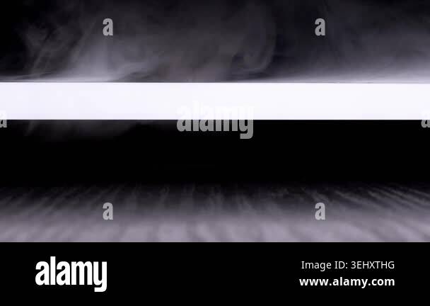 Thick white smoke curls and drifts horizontally above a glowing white ...