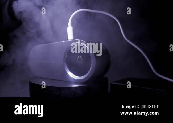 A sleek portable humidifier with a digital display charges via a USB ...