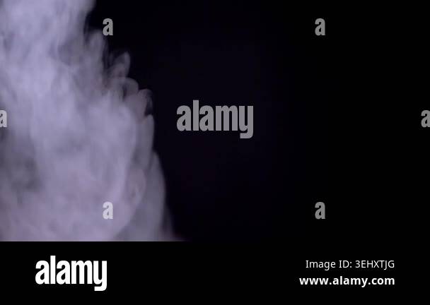 Thick white vapor rises slowly on the left side of the frame against a ...