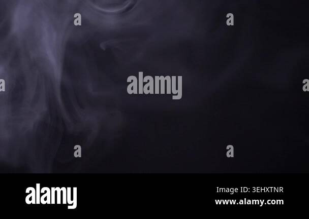 Thick white smoke drifts slowly upwards and swirls gently against a ...