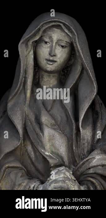 Looped animated video of Isolated imagen of a stone statue of a robed ...