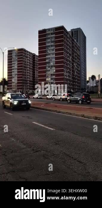 Three quarter shot video of cars crossing at avenue at sunset time in ...