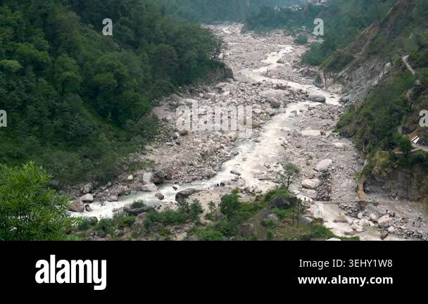 Aerial view of a narrow mountain path surrounded by rocky slopes and ...