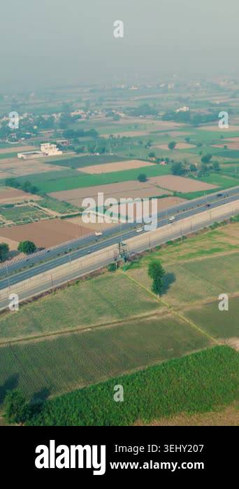 An aerial drone shot captures the expansive Ganga Expressway, a major ...