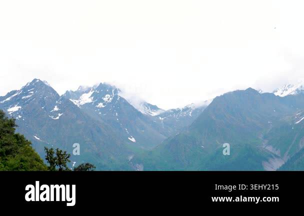 Panoramic view of rugged Himalayan mountains with snow-covered summits ...