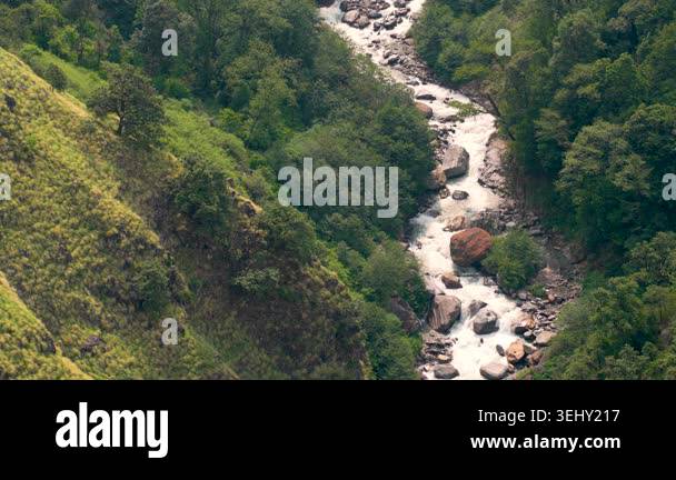 High-altitude aerial perspective of a meandering glacial river flowing ...