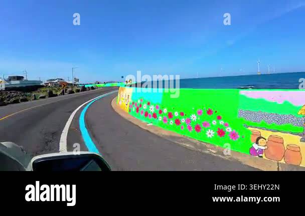 Jeju Island, South Korea - April 24 2026: Driving along a colorful road ...