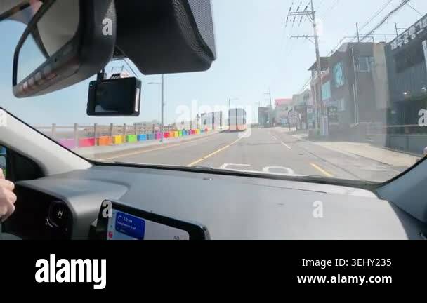 Jeju Island, South Korea - April 24 2026: Driving along a colorful road ...
