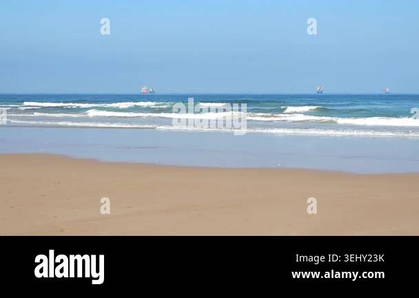 Wide sandy beach on the Atlantic Ocean coast in Agadir, Morocco. Gentle ...