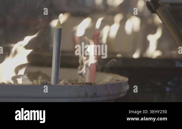 Lighting candles to worship Buddha statues in temples is a traditional ...
