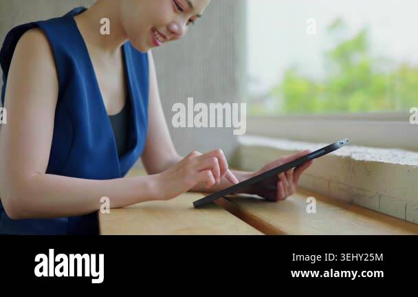 Businesswoman using tablet while sitting at table Stock Video Footage ...
