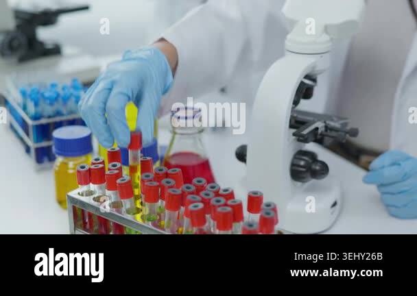 Scientist holding test tube near microscope equipment Stock Video ...