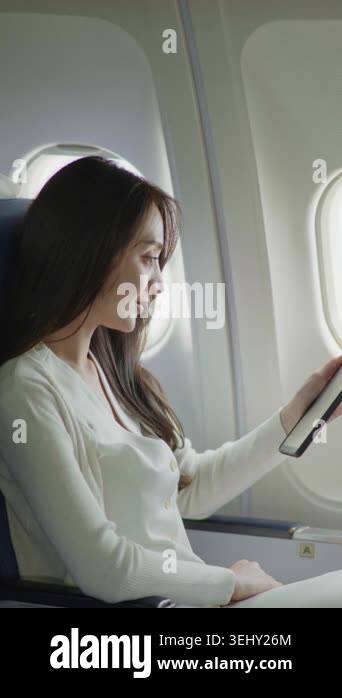 Businesswoman reading ebook while sitting on airplane Stock Video ...